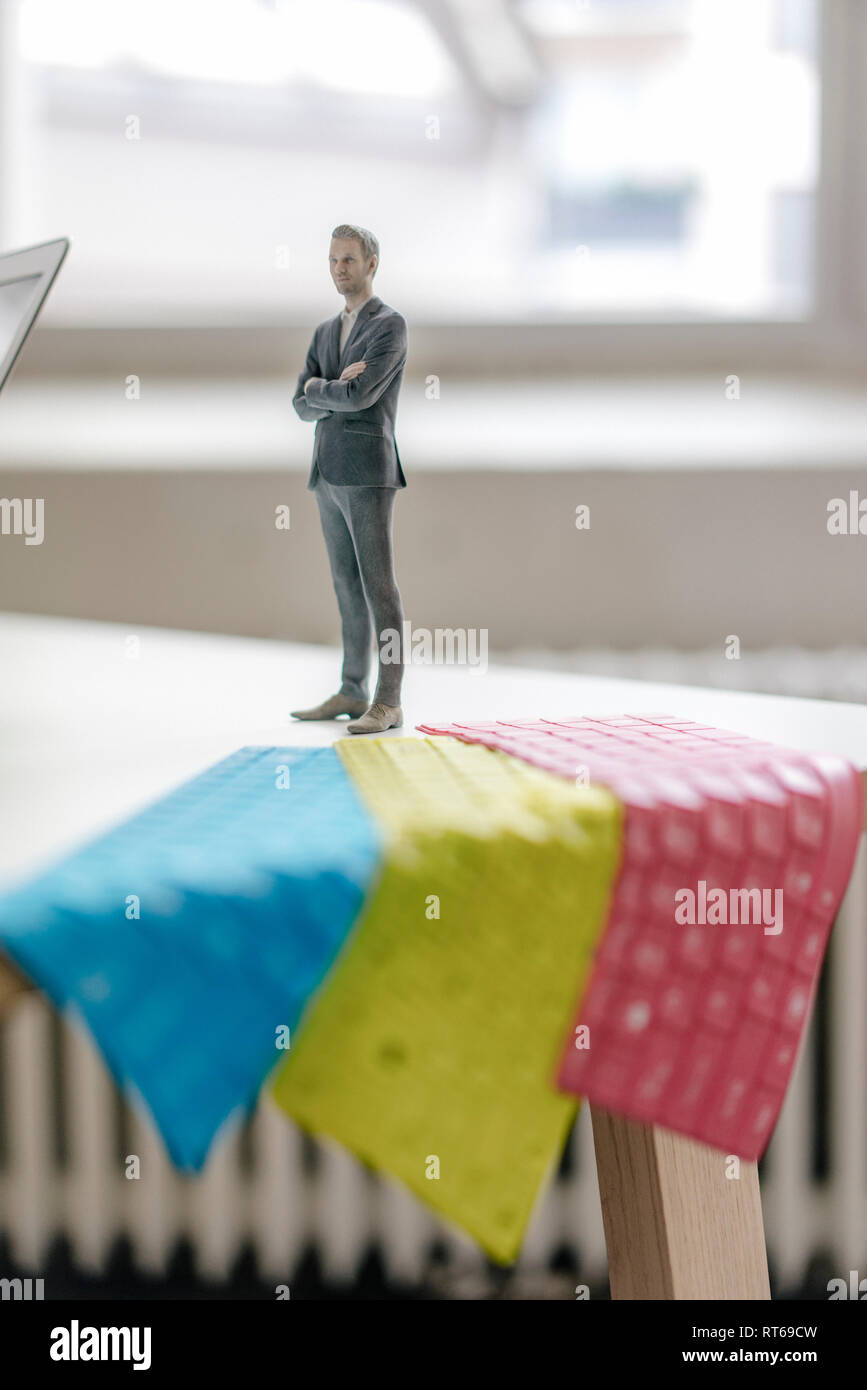 Businessnessman figurine standing on desk with tablet keyboards Stock ...
