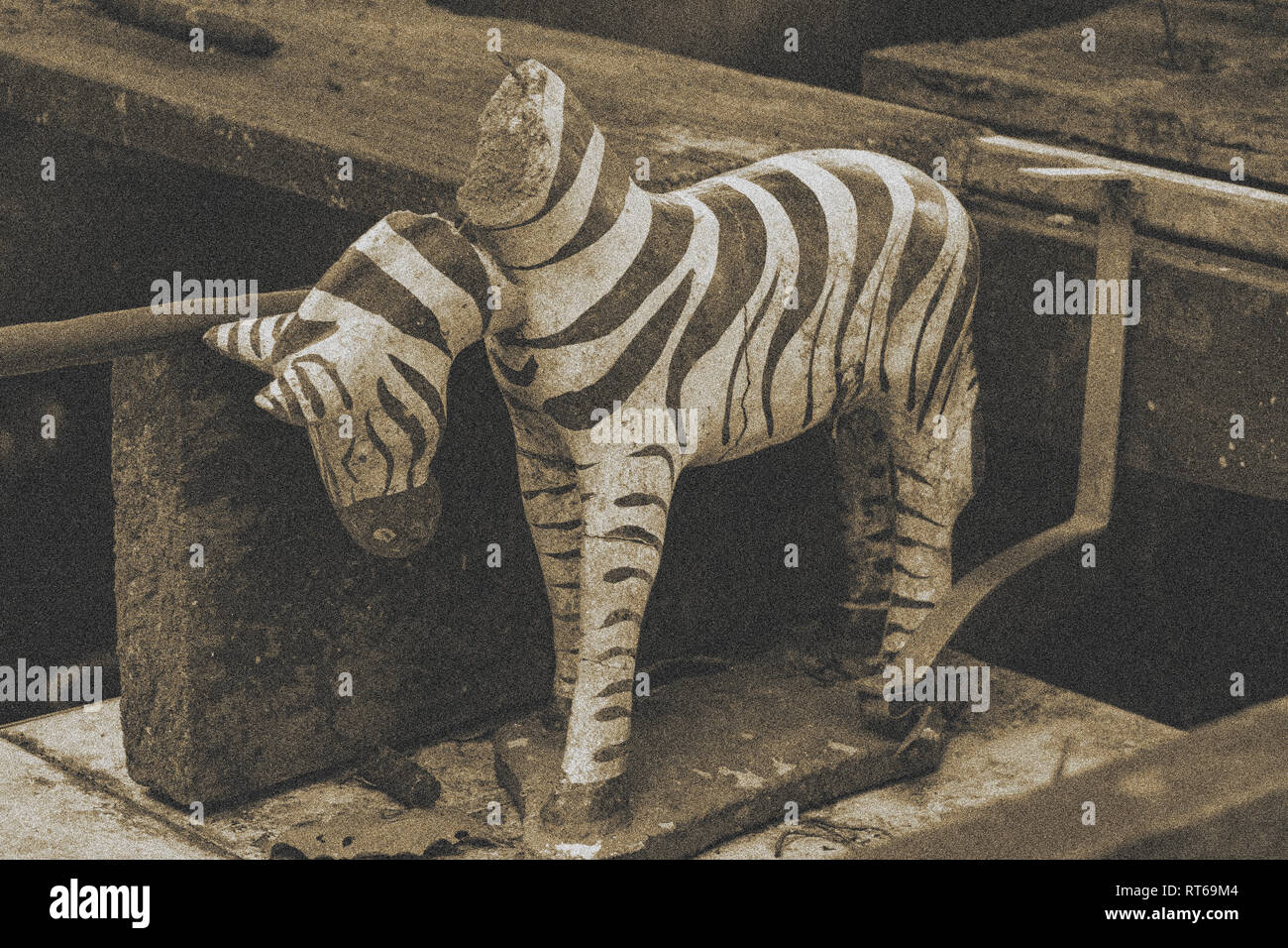 The damaged statue of zebra with a falling head, close up.The variant ...