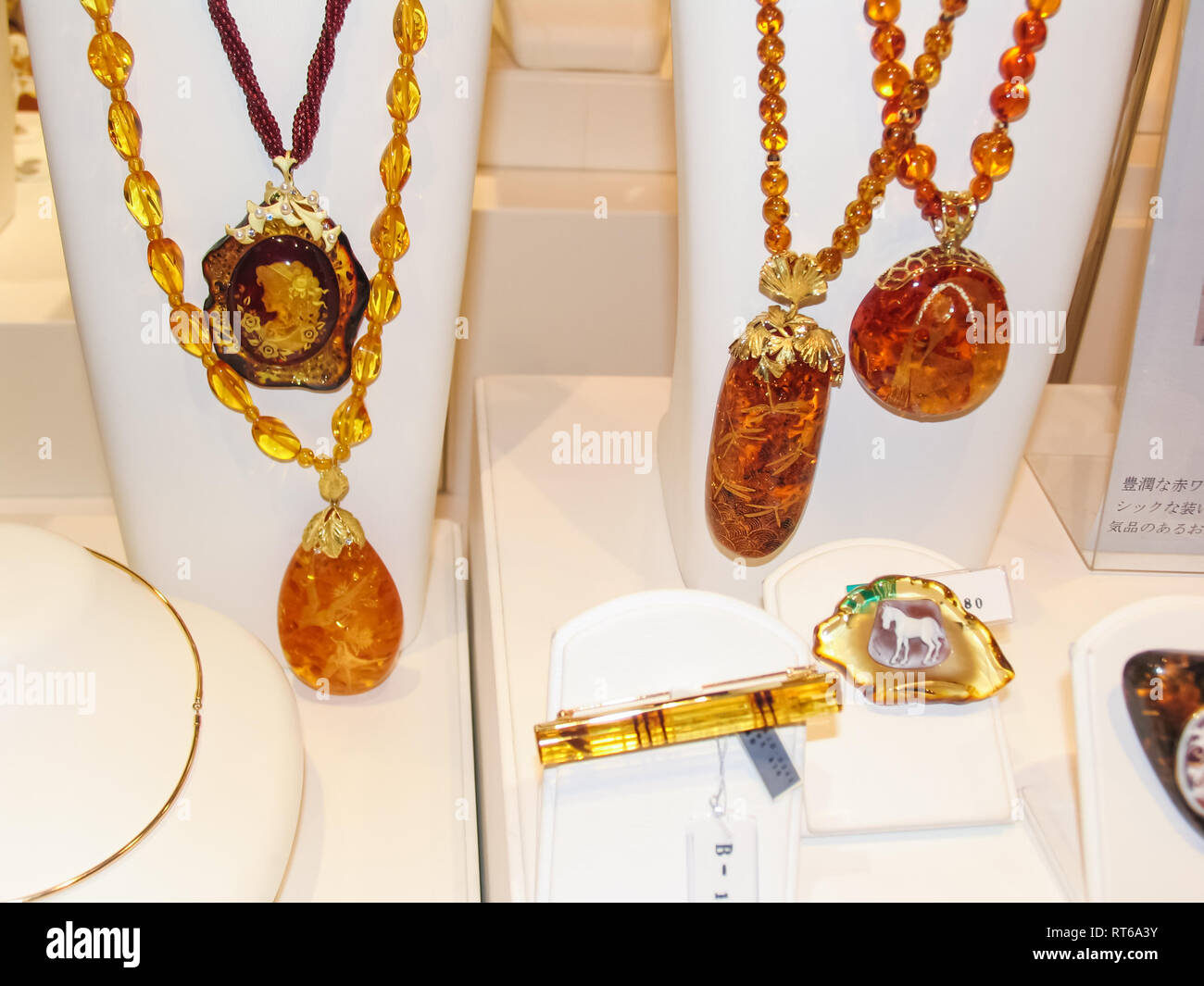Products and jewelry from amber. Processed amber Stock Photo - Alamy