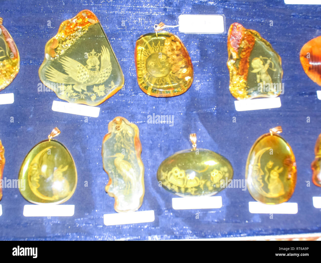 Products and jewelry from amber. Processed amber Stock Photo - Alamy