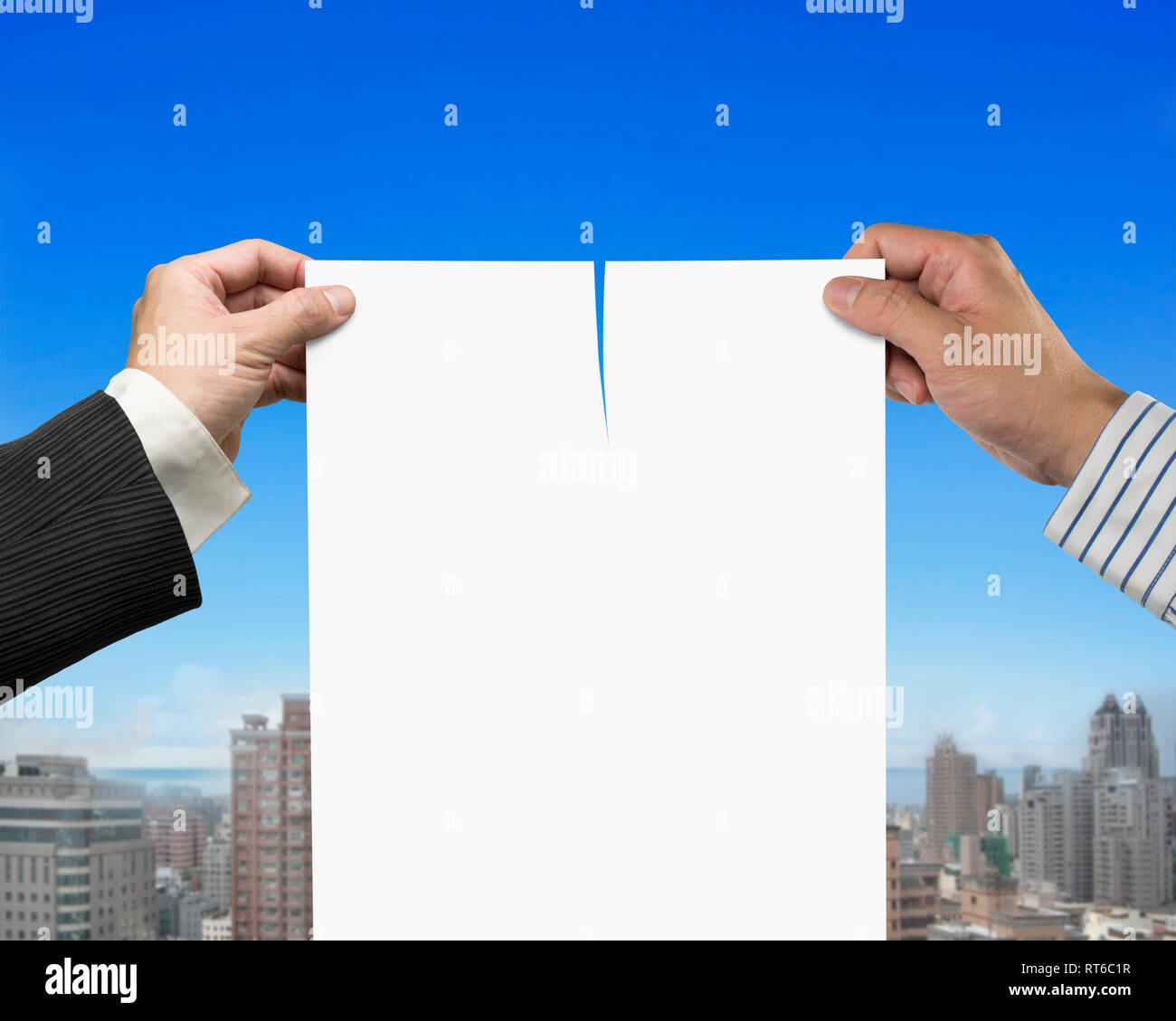 Two man's hands holding the tearing contract paper with blank white, on ...