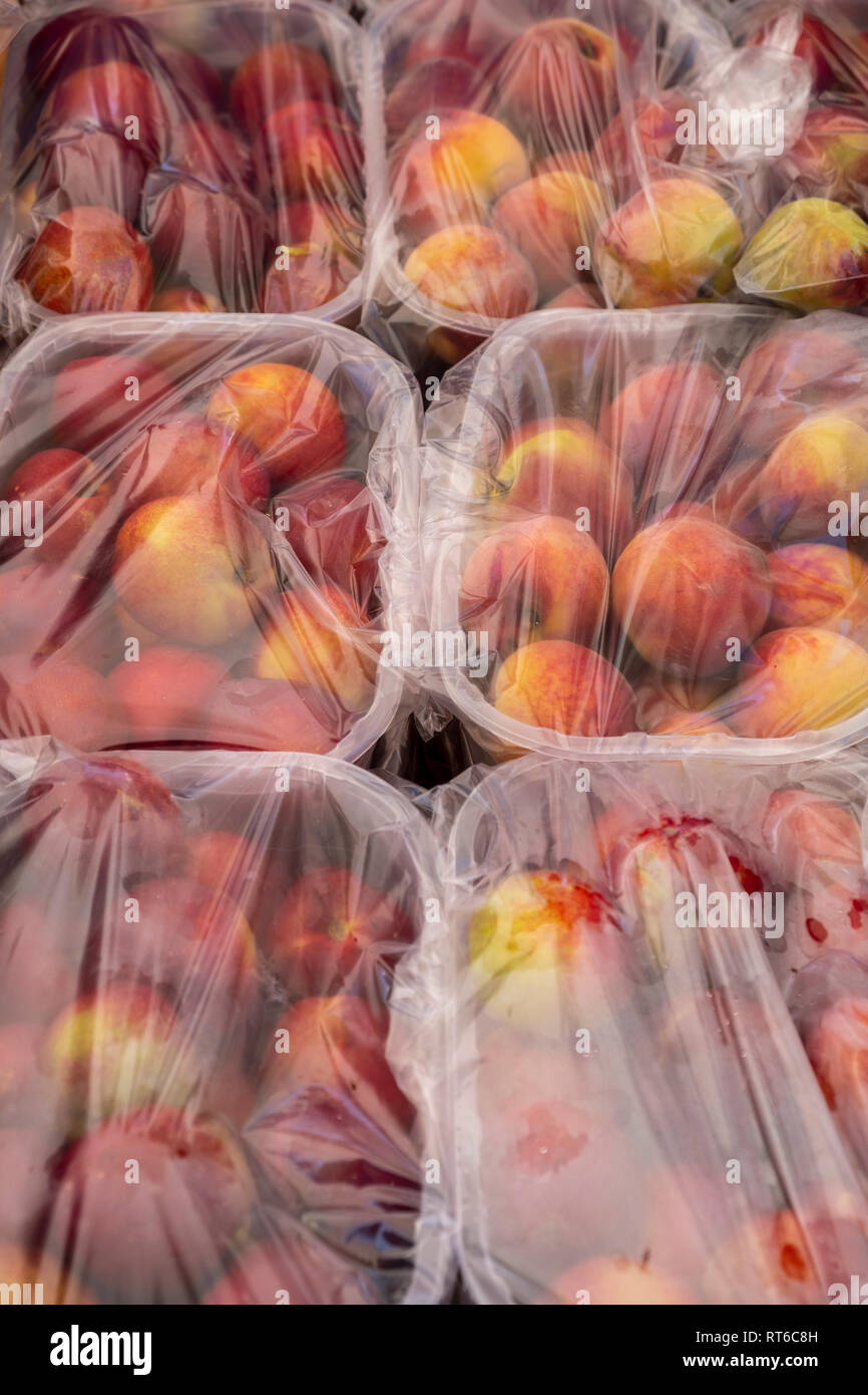 Nectarines wrapped in plastic Stock Photo - Alamy