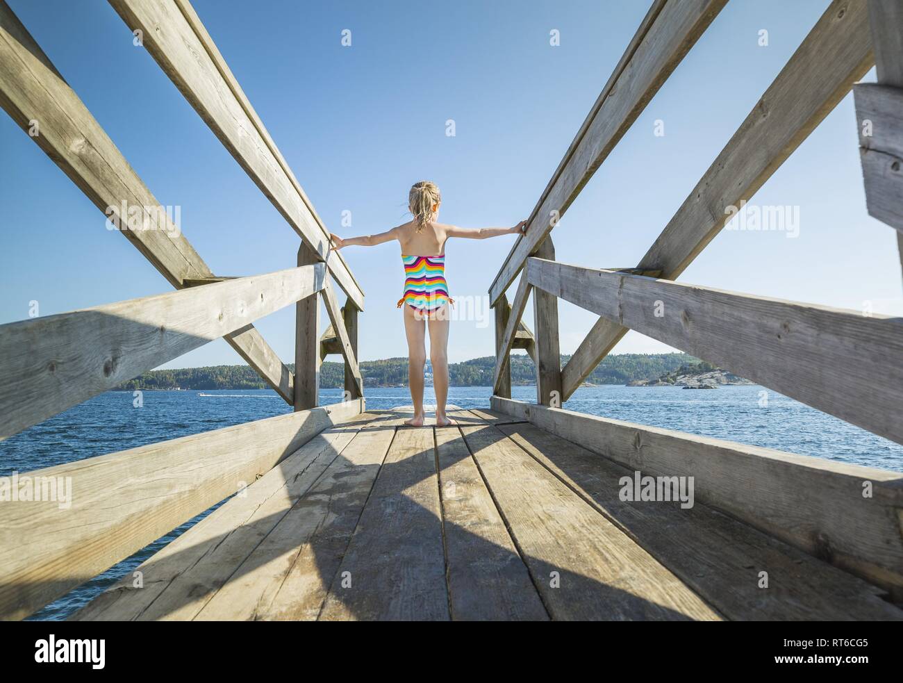 Plank on the water with a blonde girl on it Stock Photo - Alamy