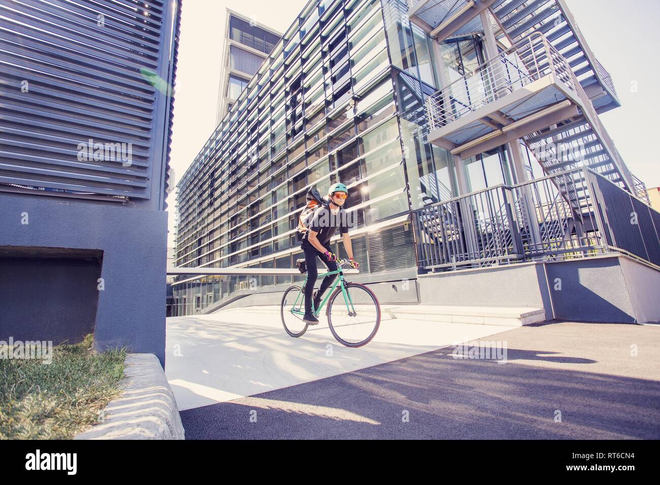 Bike messenger with huge backpack in the city Stock Photo - Alamy