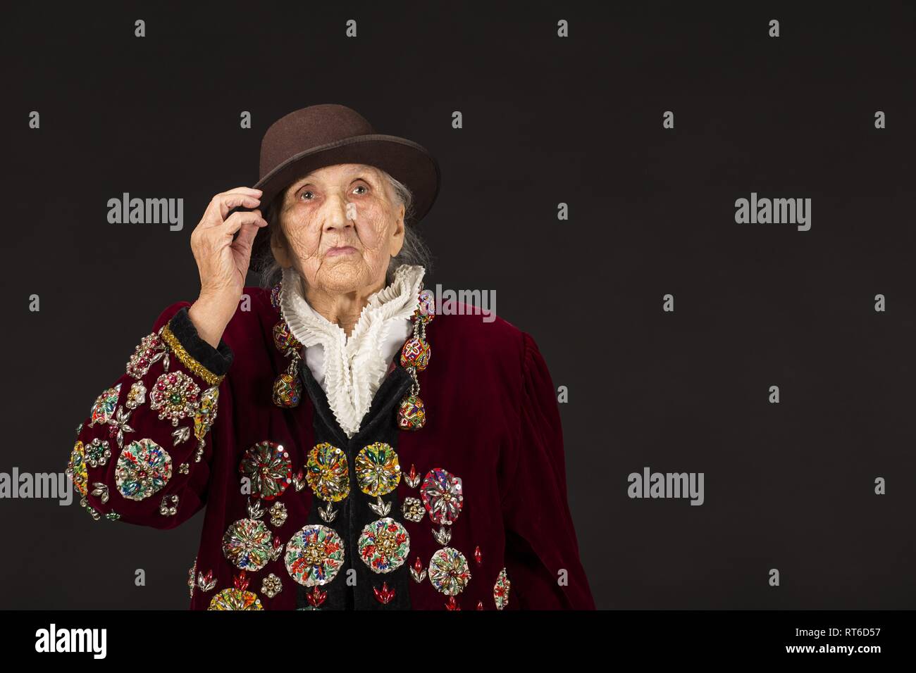 Vintage old woman in ethno needelworked jacket Stock Photo - Alamy