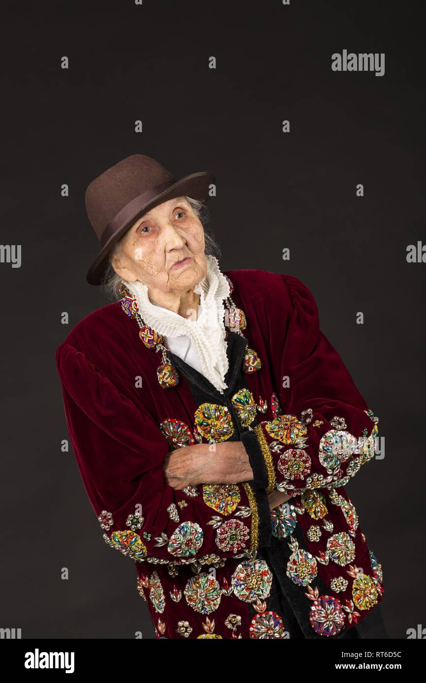 Vintage old woman in ethno needelworked jacket Stock Photo - Alamy