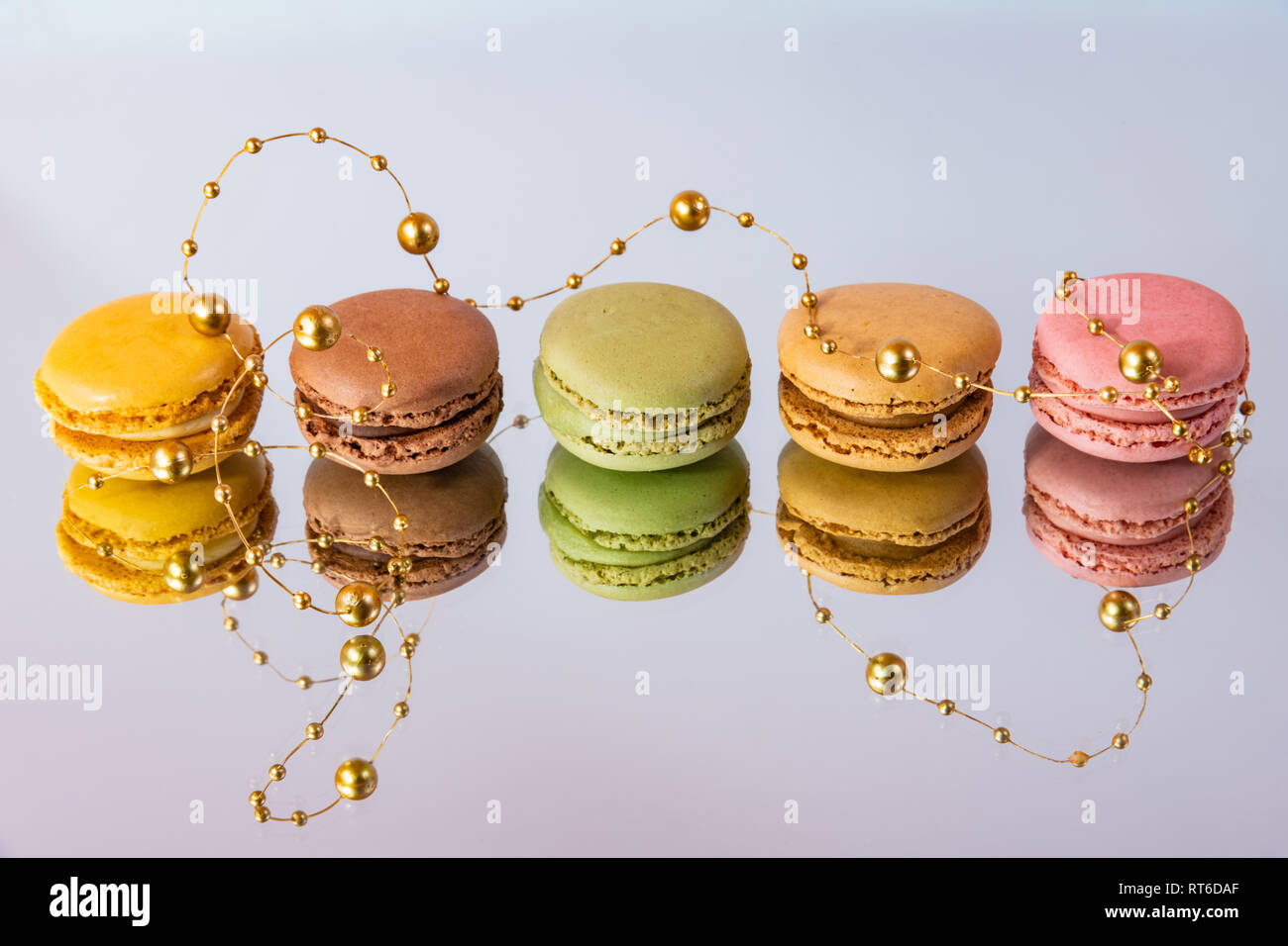 Tasty colorful macaroon homemade isolated on a mirror and a colorful ...