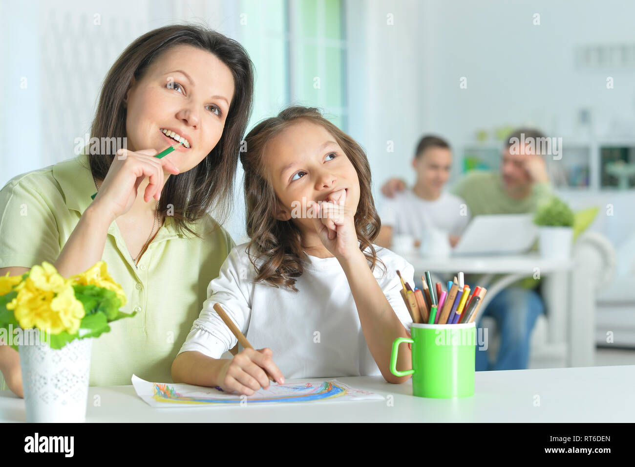 Loving mother daughter sitting table hi-res stock photography and ...