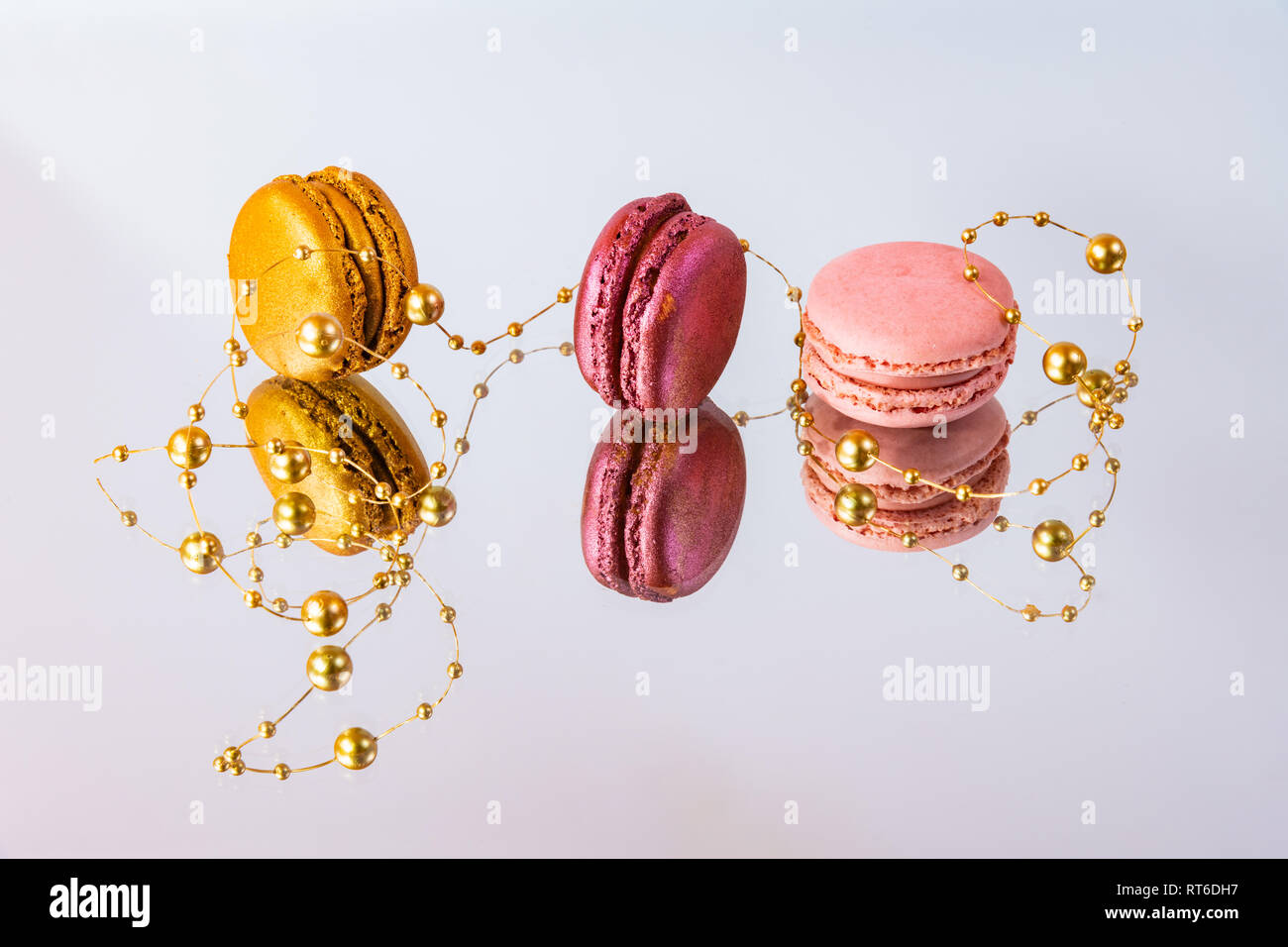 Tasty colorful macaroon homemade isolated on a mirror and a colorful ...