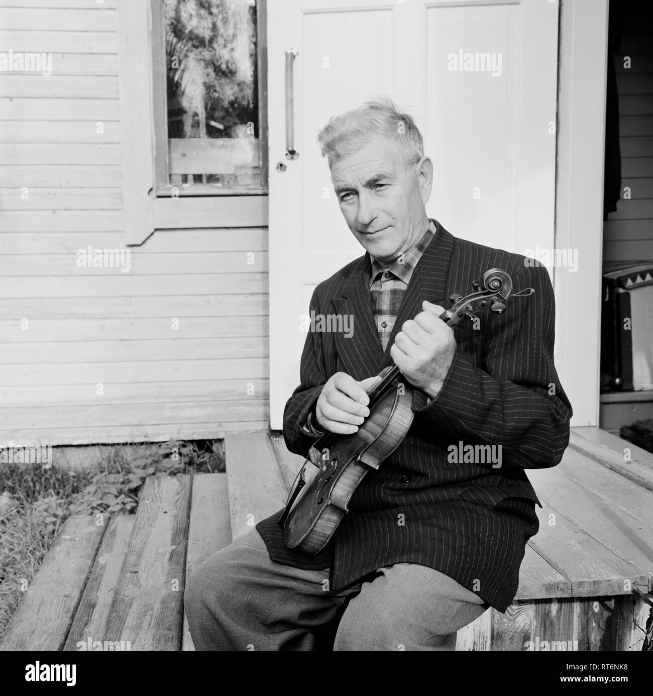 Finland History - Man playing violin sitting on a porch in Kannus ...