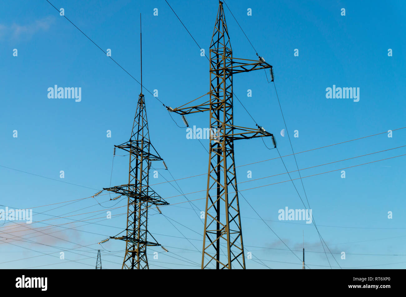 Two high voltage electric line poles viewed from low angle against ...