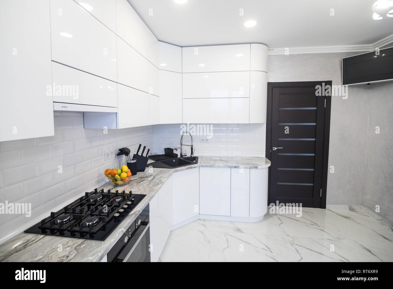Modern minimalistic kitchen with gas cooktop and accesories Stock Photo ...