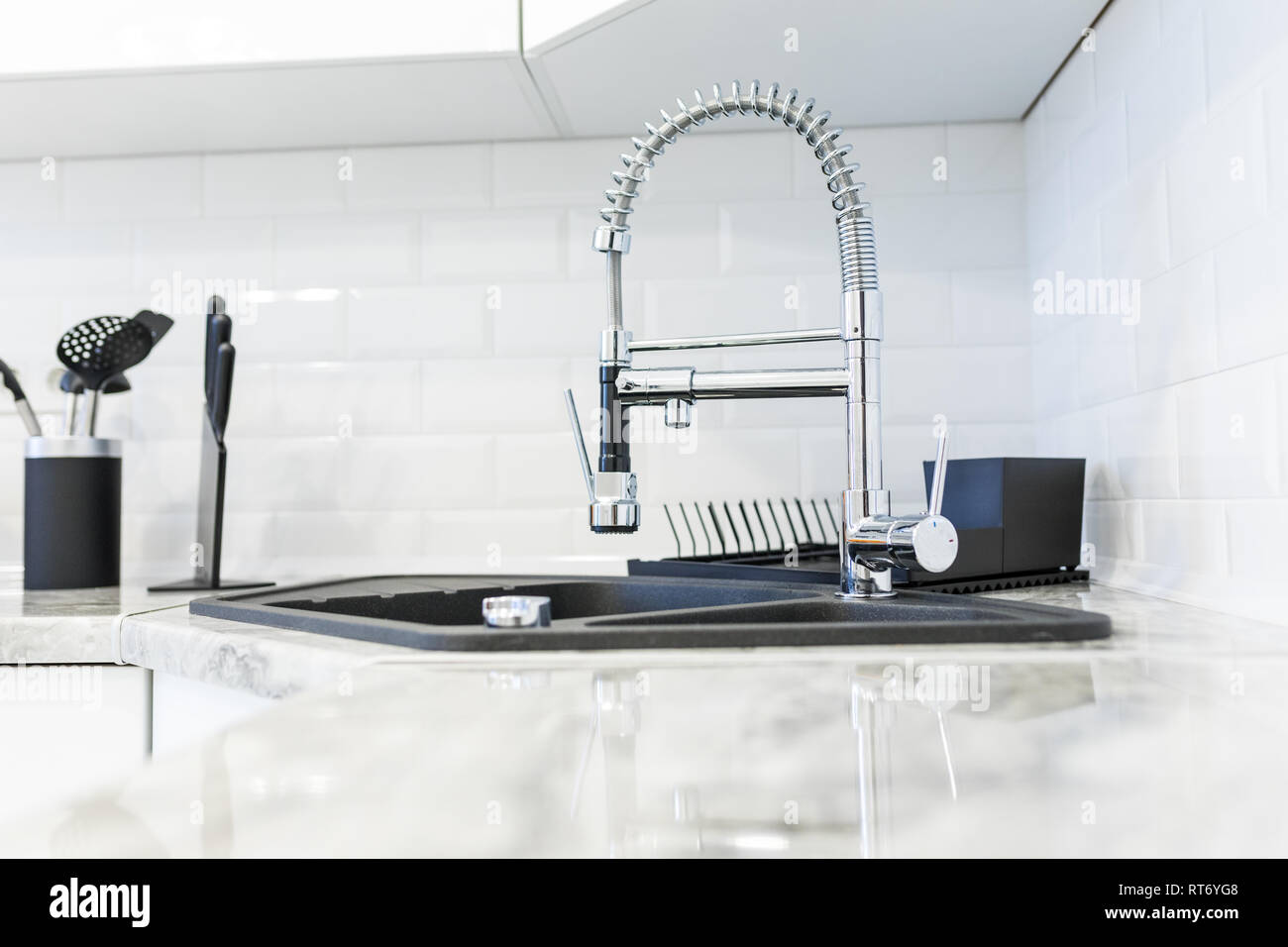 Photo of a nice, fancy sink in a mostly white kitchen Stock Photo - Alamy