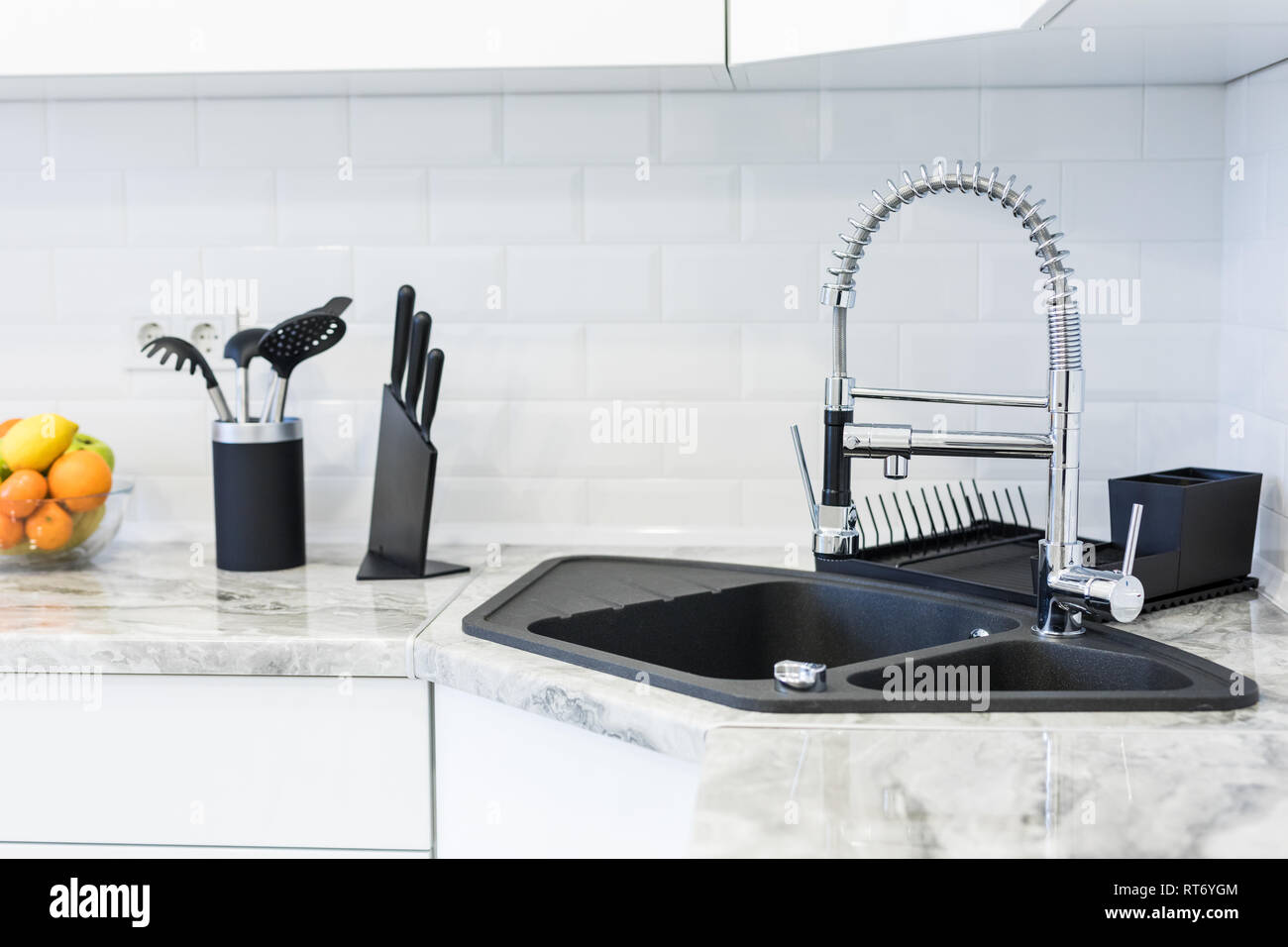 Photo of a nice, fancy sink in a mostly white kitchen Stock Photo - Alamy