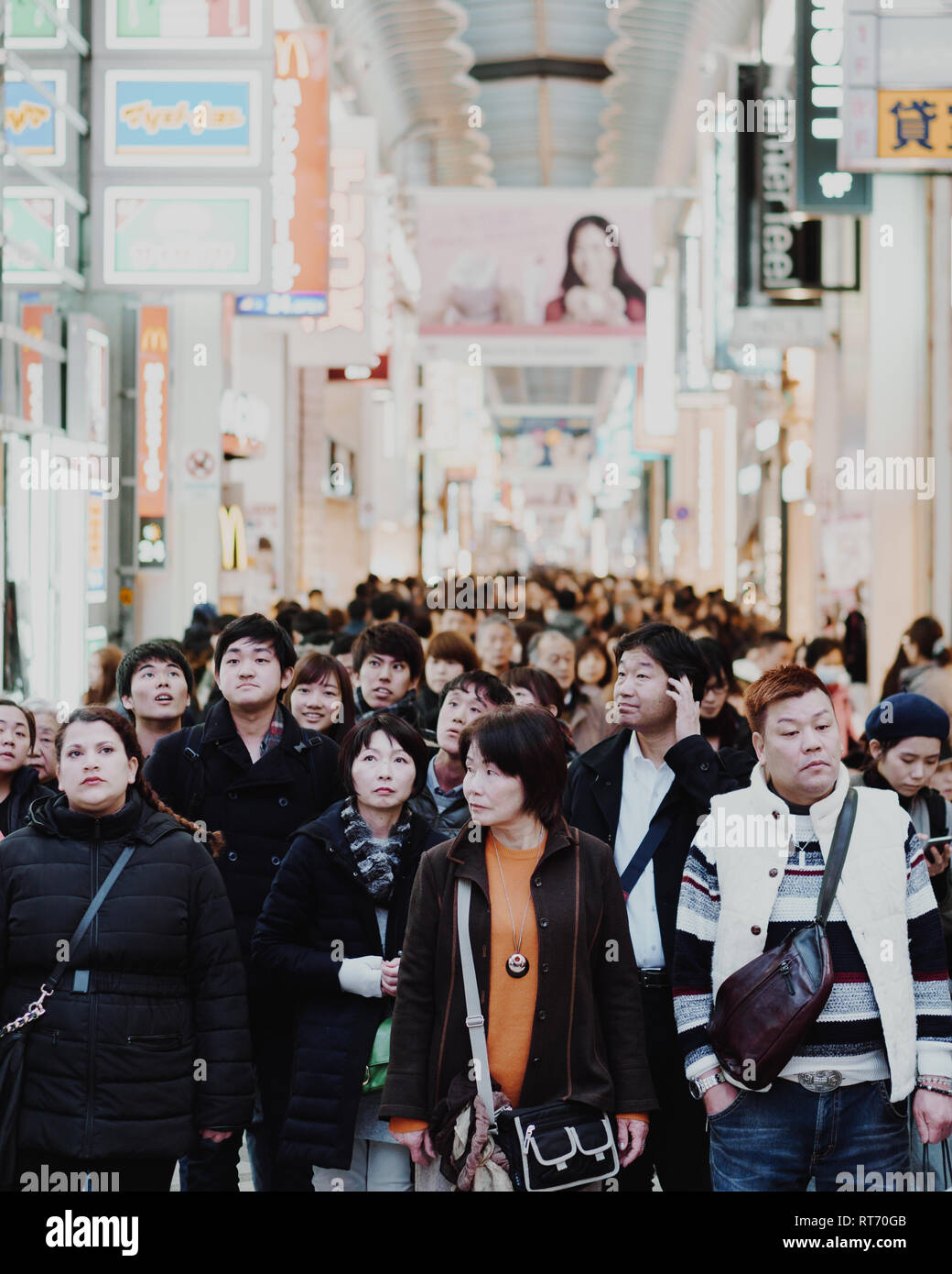Massive crowd of people all looking at different things waiting at a ...