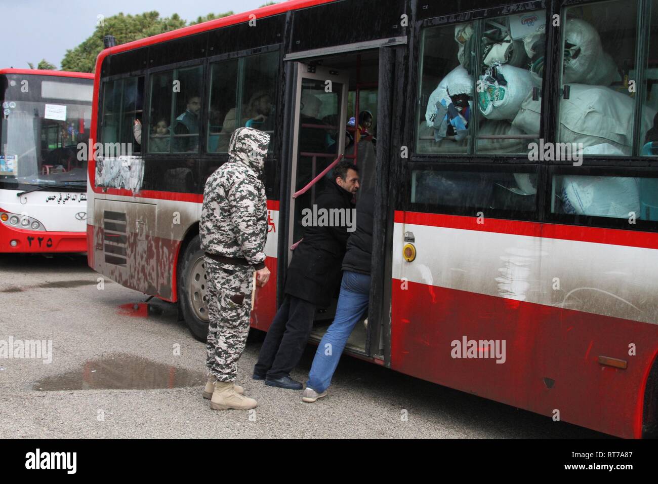 Beirut, Lebanon. 28th Feb, 2019. A Syrian refugee (2nd L) takes a coach ...