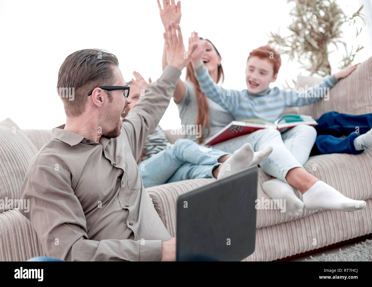happy family giving high five in their living room Stock Photo - Alamy