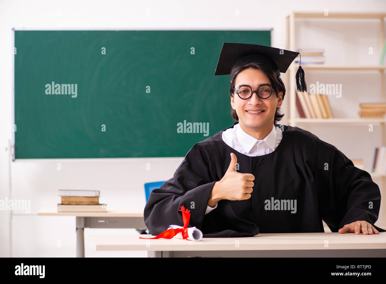 Excited graduating student thumbs up hi-res stock photography and ...
