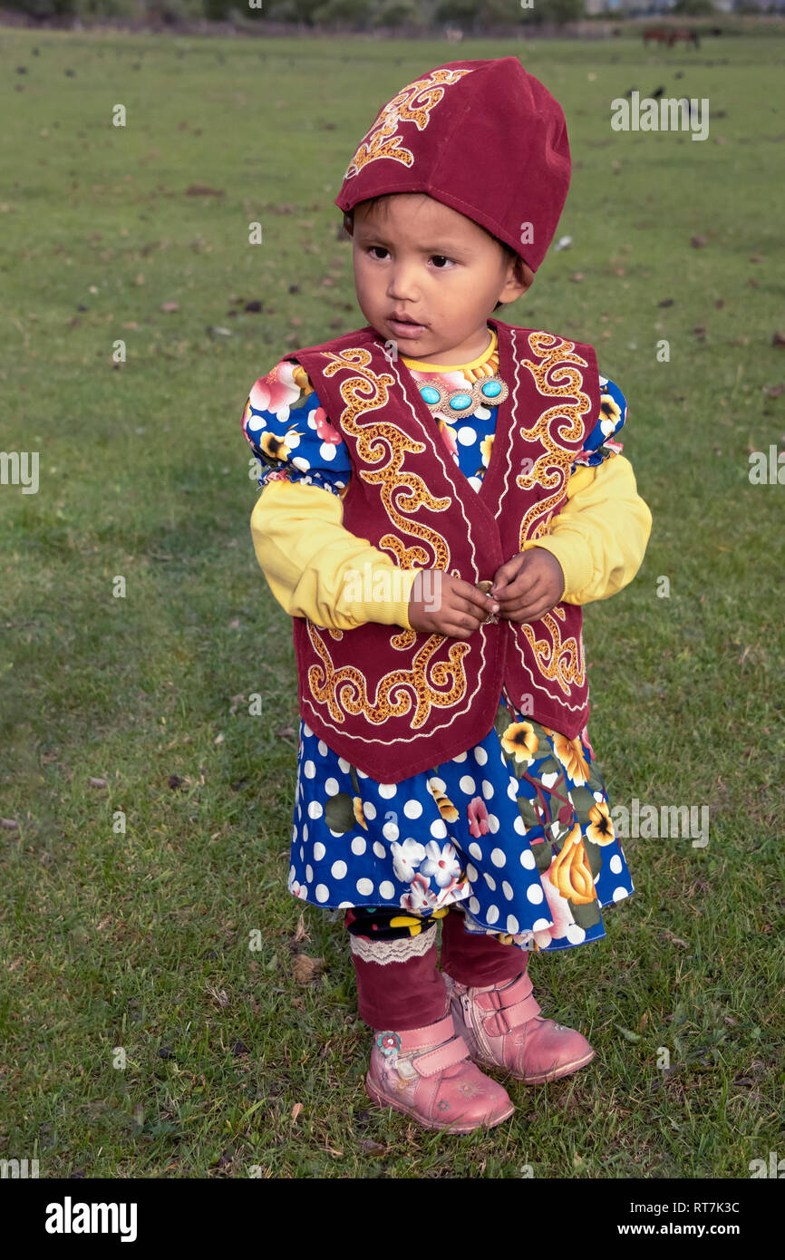 Portrait of a small Kazakh girl at a yurt raising, Saty, Tian Shan ...