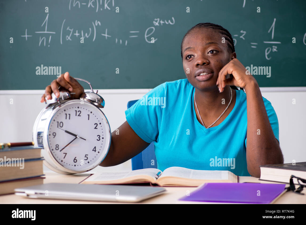 Black female student in front of chalkboard Stock Photo - Alamy