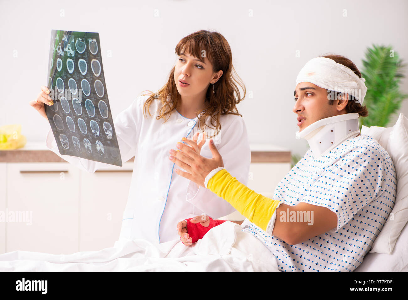 Young doctor examining injured patient Stock Photo - Alamy