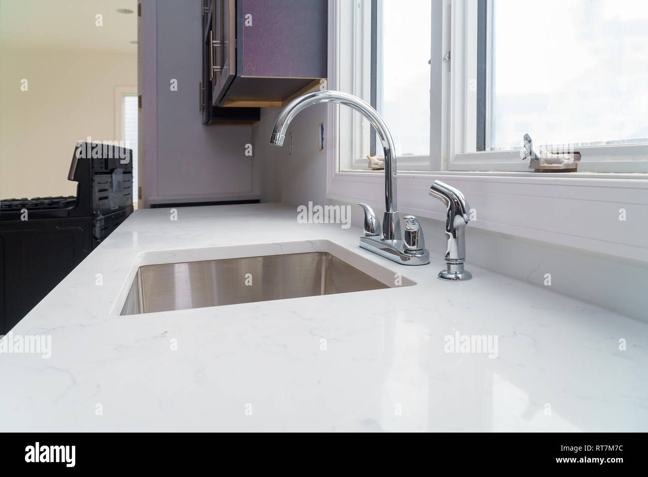 Faucet and kitchen faucet and countertop detail sink with brick wall ...