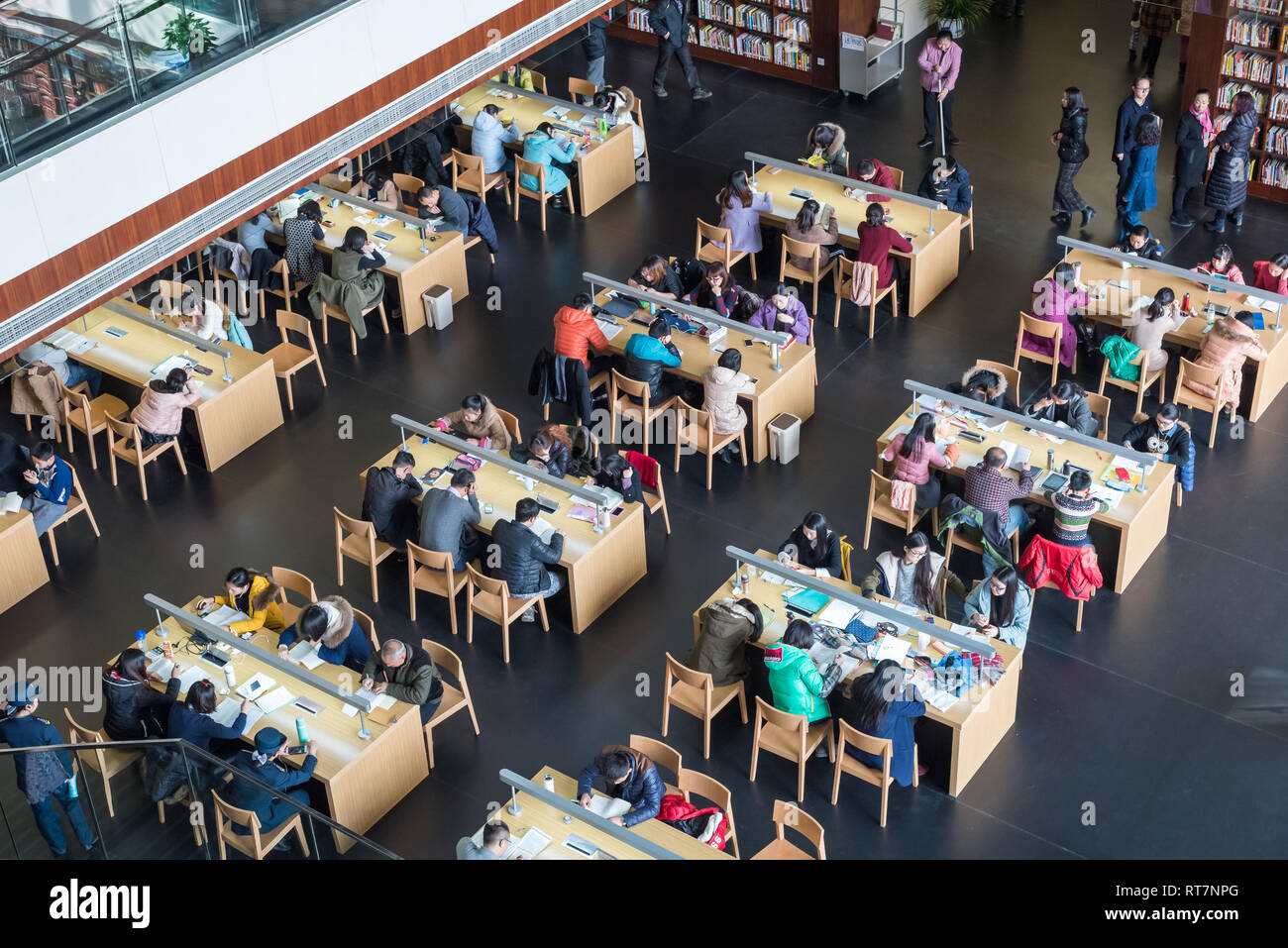 Chengdu, Sichuan province, China - Jan 21, 2016 : People reading in the ...