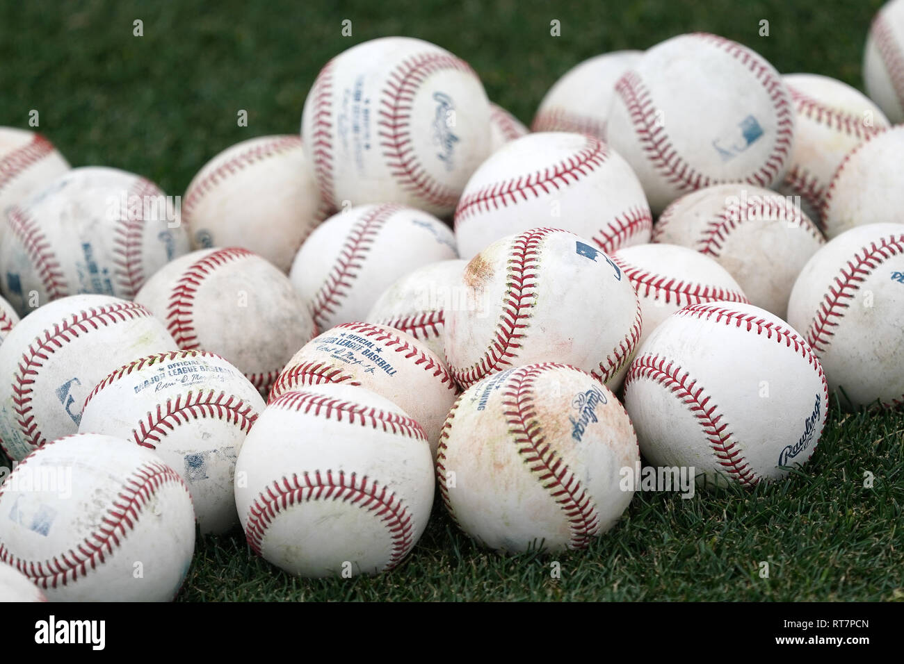 A pile of baseballs on the infield grass Stock Photo - Alamy