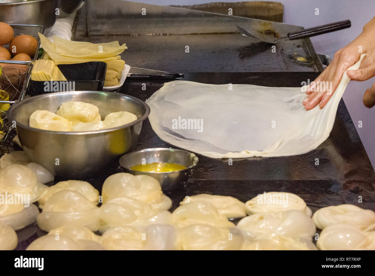 Making of Roti Canai, cooking process, Indian traditional street food ...