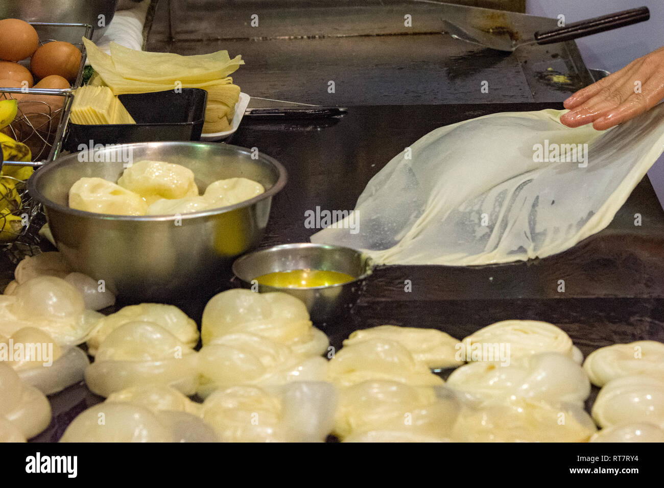 Making of Roti Canai, cooking process, Indian traditional street food ...