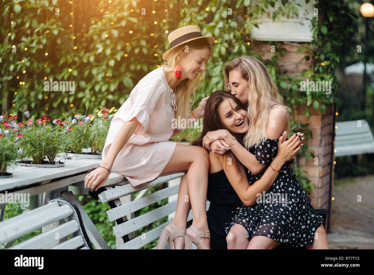 three girls on the bench Stock Photo - Alamy