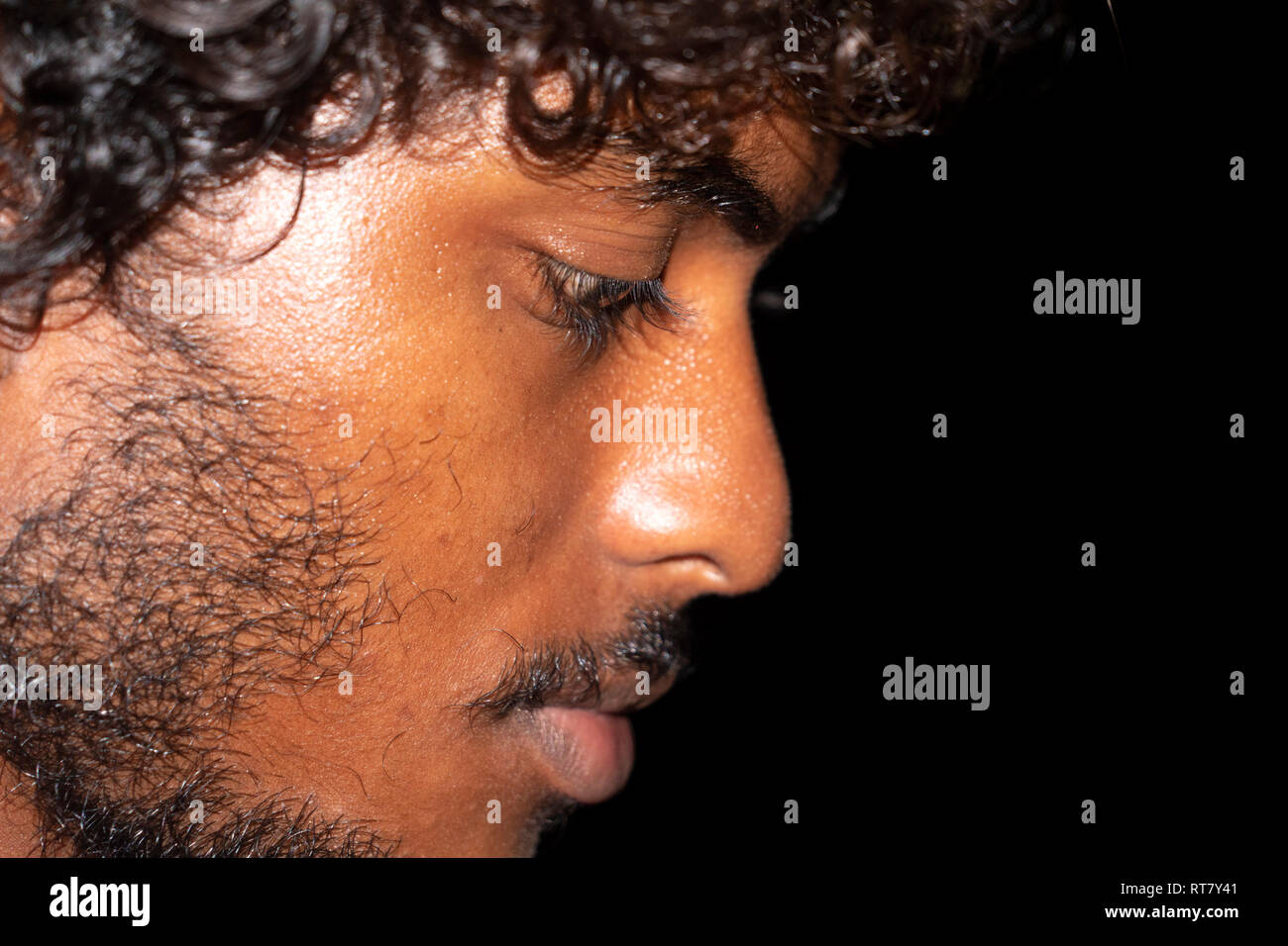 Young maldives man portrait on black Stock Photo - Alamy
