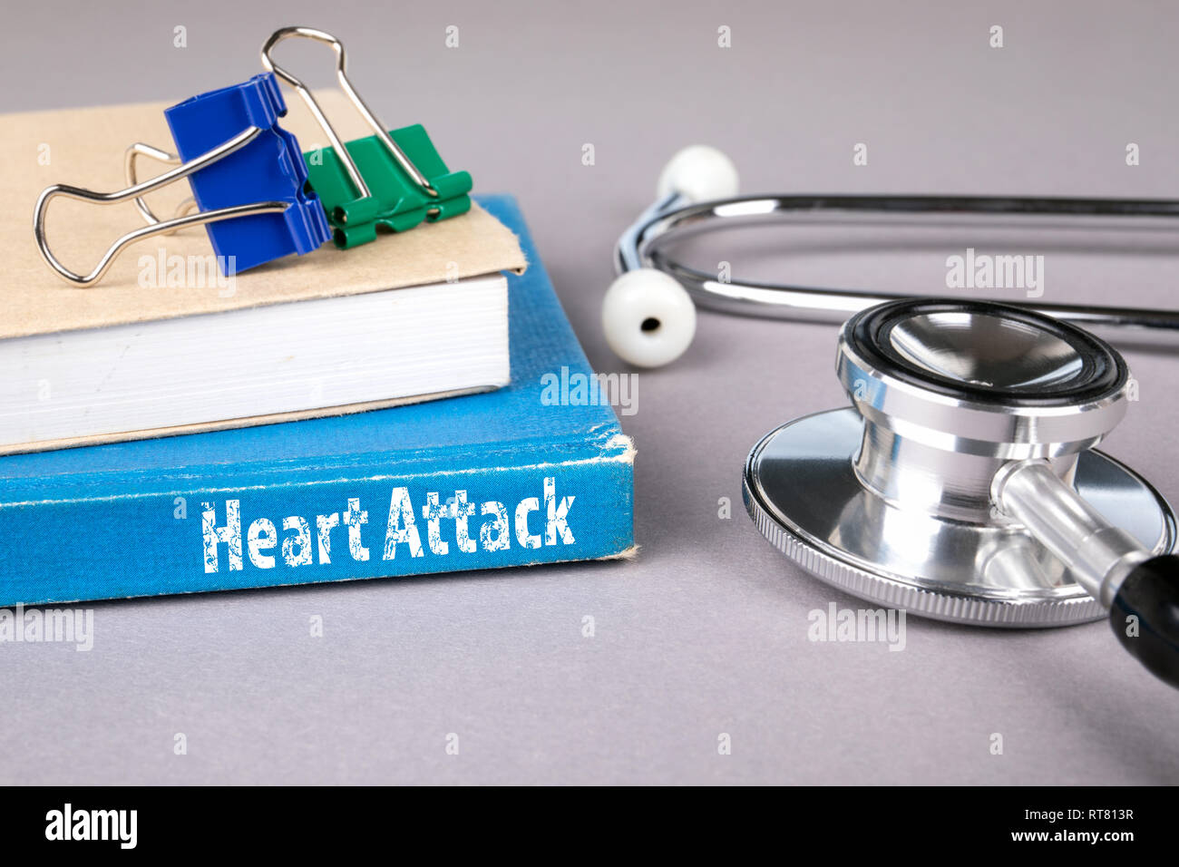 Heart Attack. Blue book on a gray office table. Communication and ...