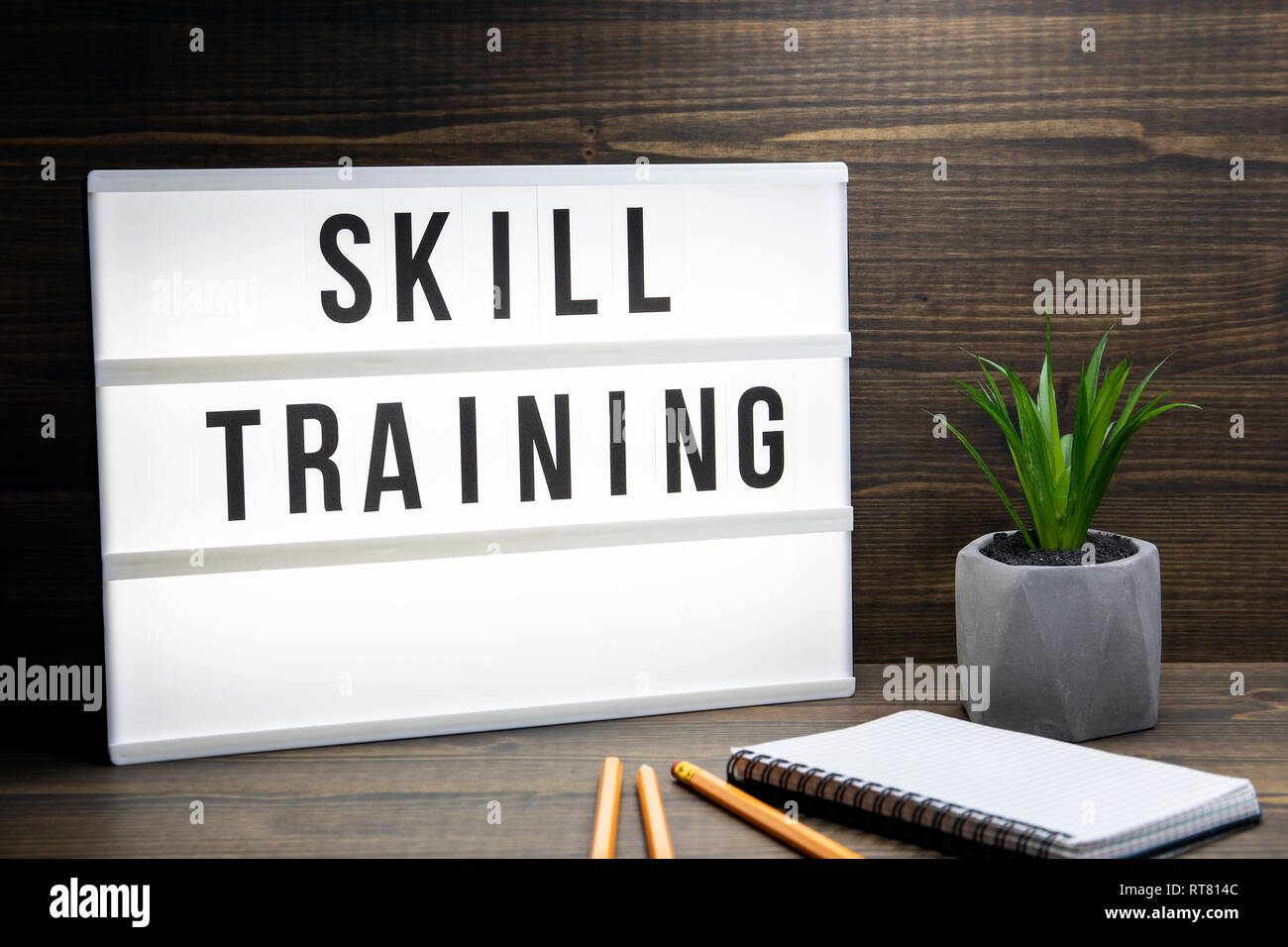 Skill Training concept. Text in lightbox. Wooden office table Stock ...