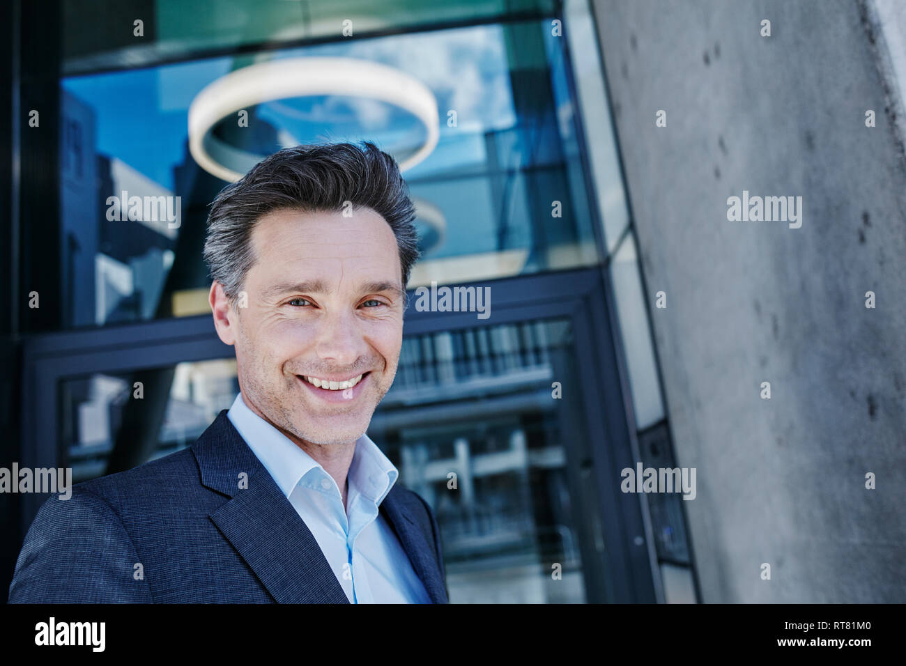 Portrait of smiling businessman Stock Photo - Alamy