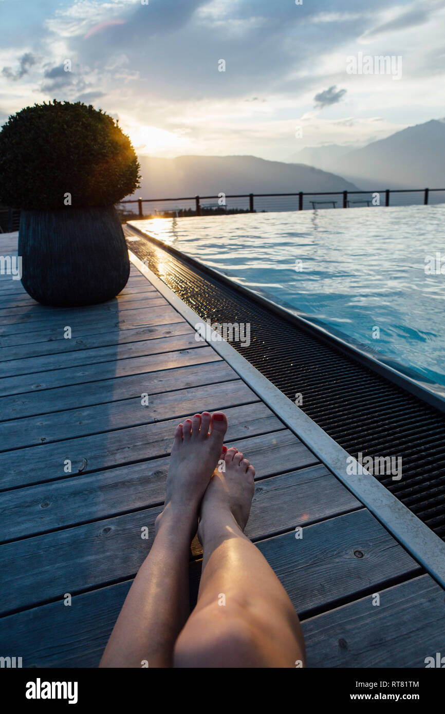 Woman relaxing at the poolside Stock Photo - Alamy