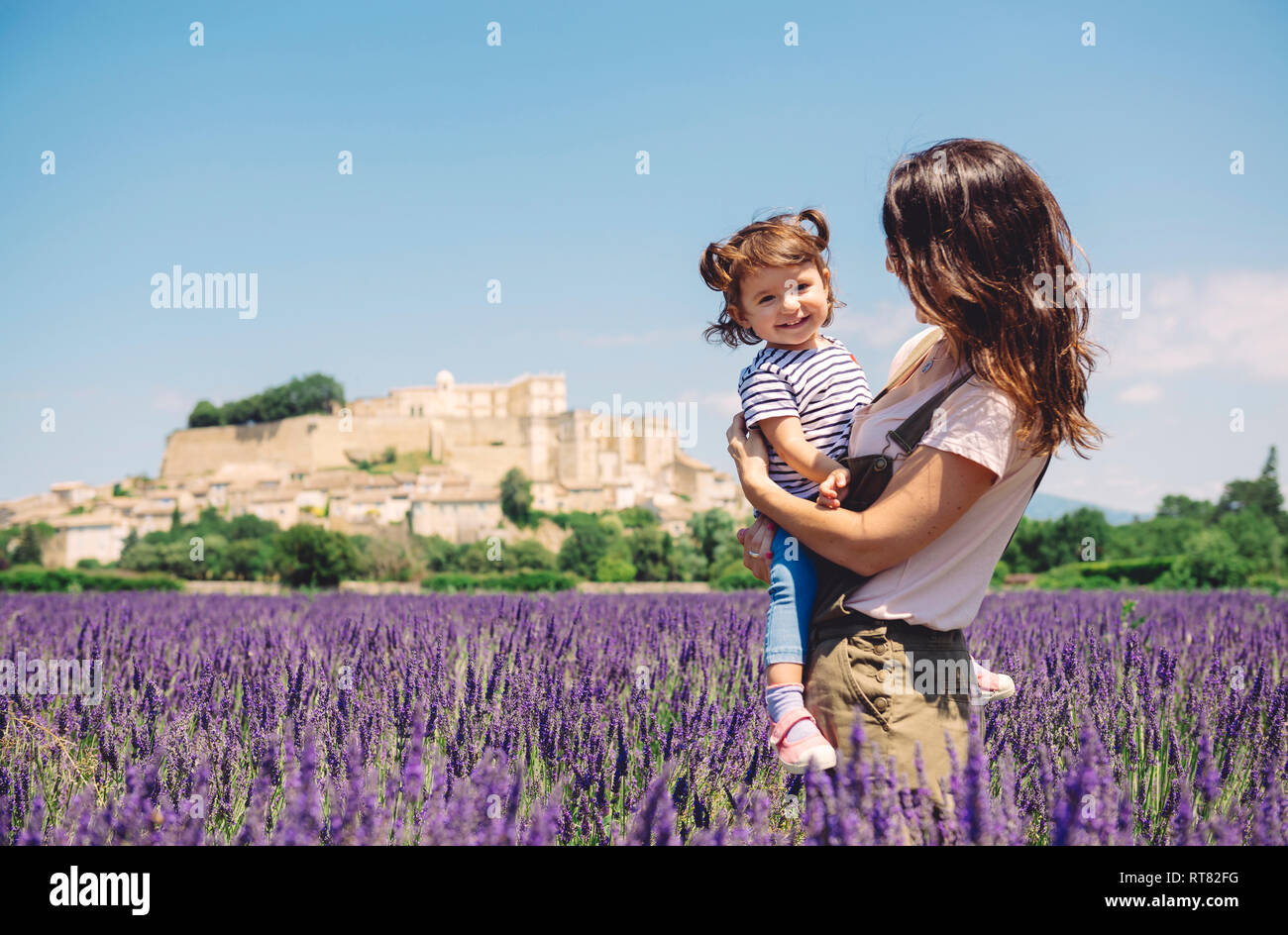 France, Grignan, portrait of happy baby girl together with her mother ...