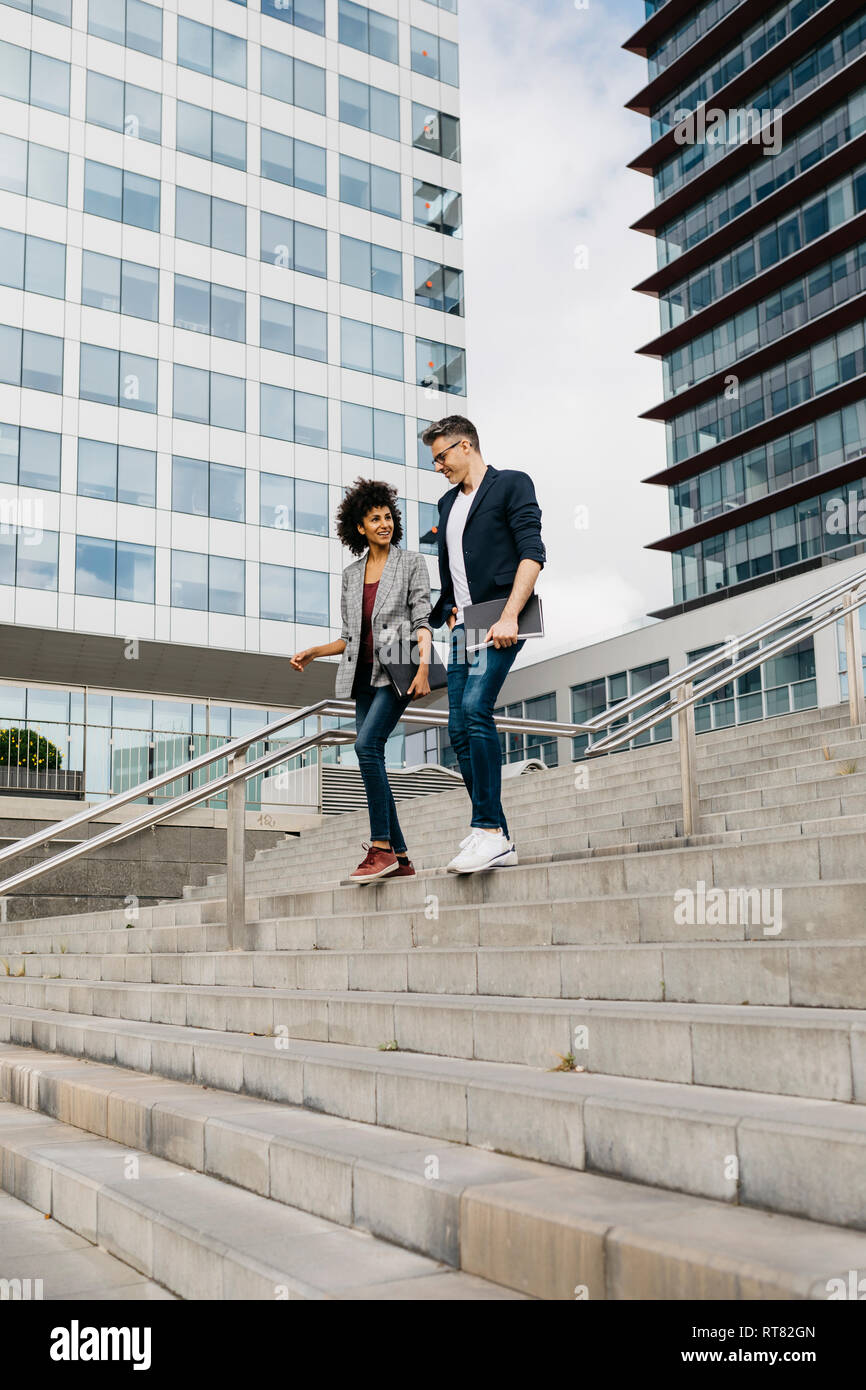 Two business people walking up stairs hi-res stock photography and ...