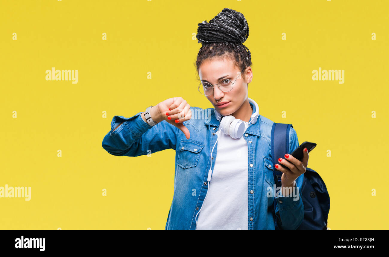 Young braided hair african american student girl using smartphone over ...