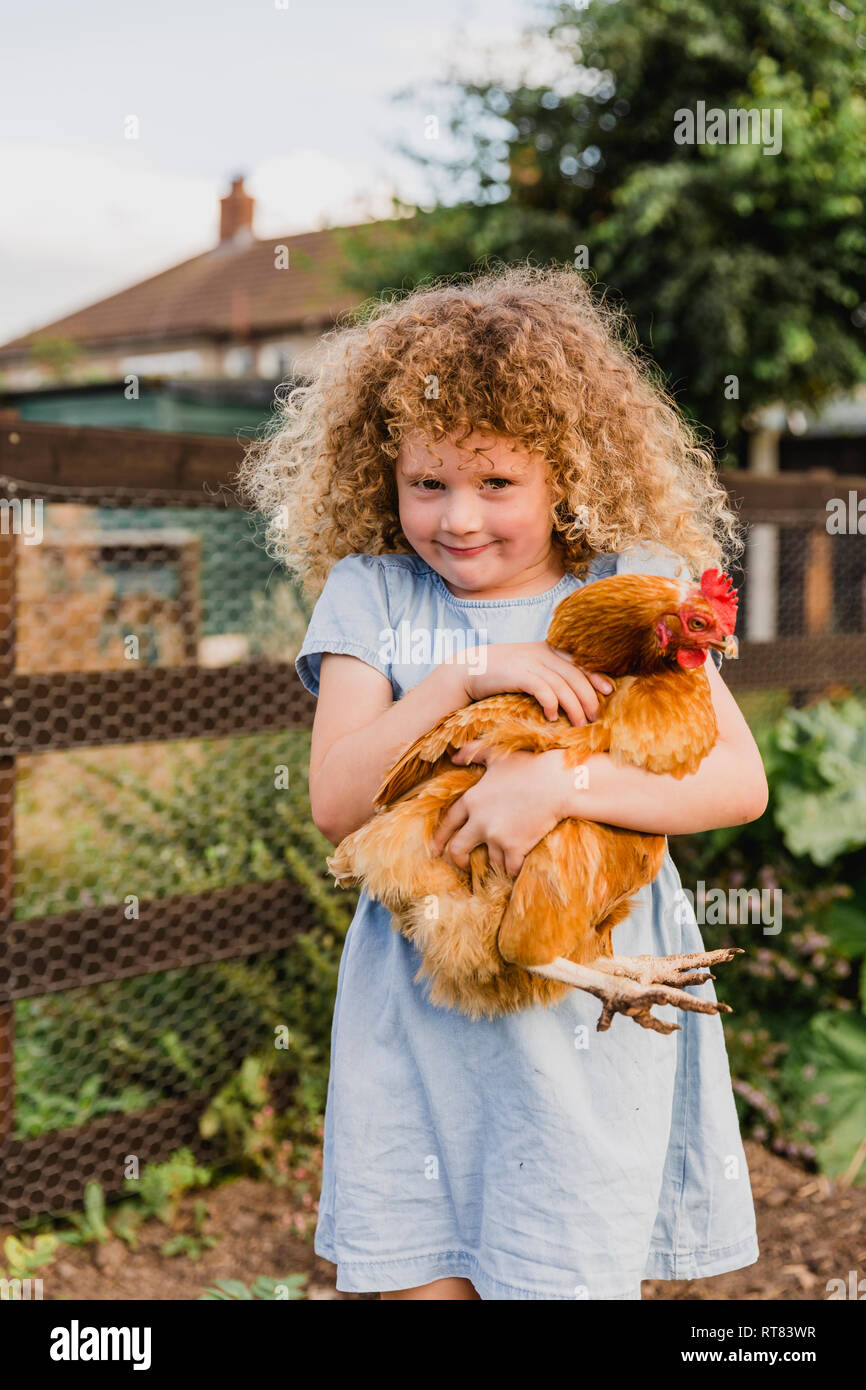 Smiling girl hugging chicken hi-res stock photography and images - Alamy