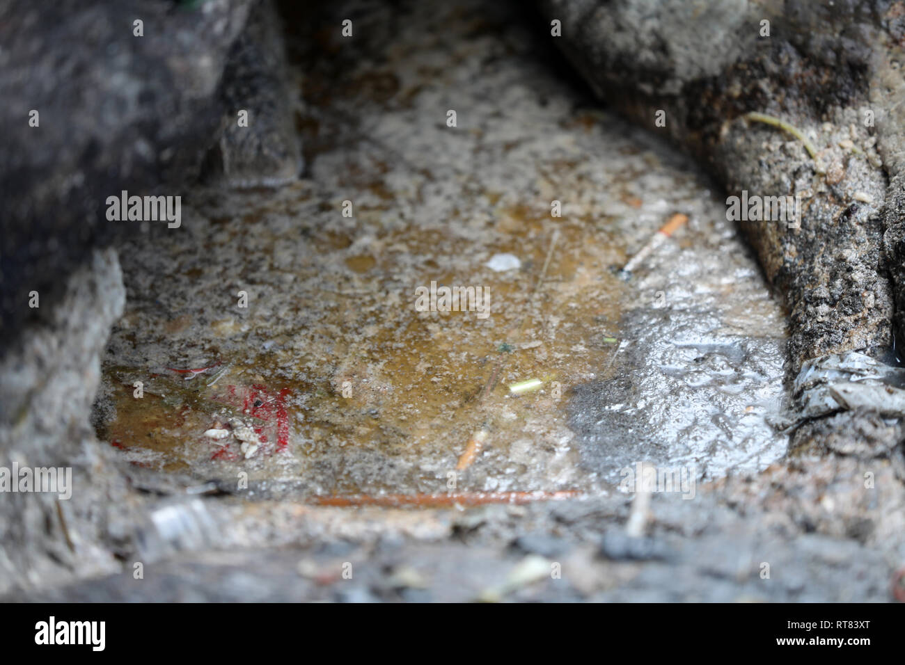 Urine dirt puddle in the city Stock Photo - Alamy