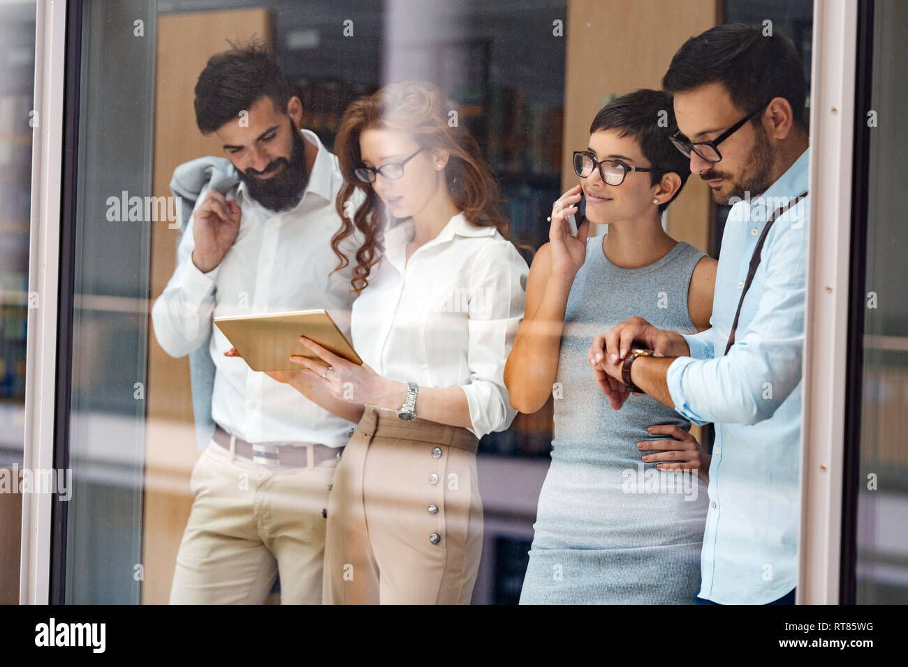 Group of young perspective businesspeople having discussion Stock Photo ...