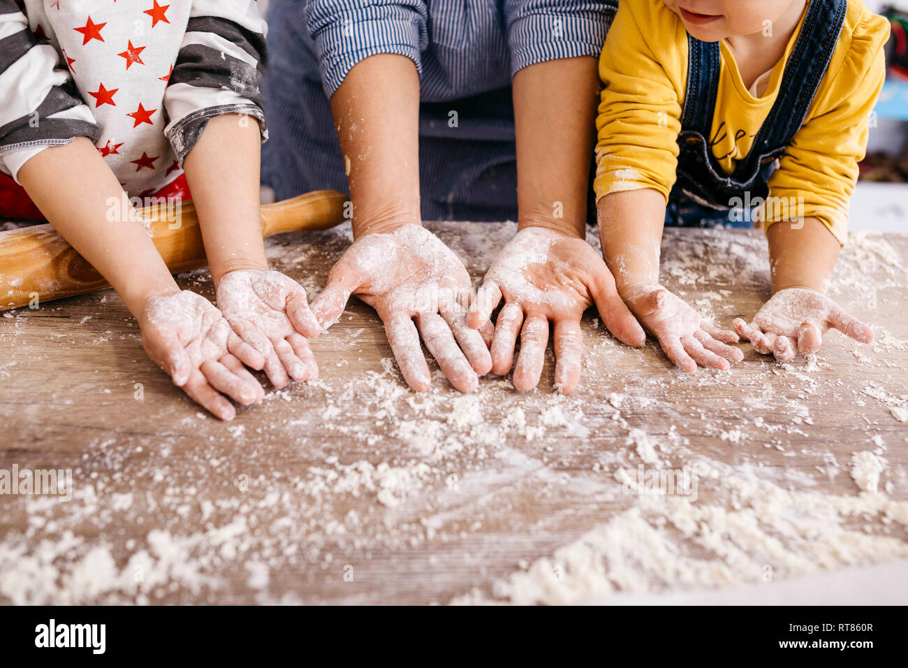 Mother and children with flour on their hands, partial view Stock Photo ...