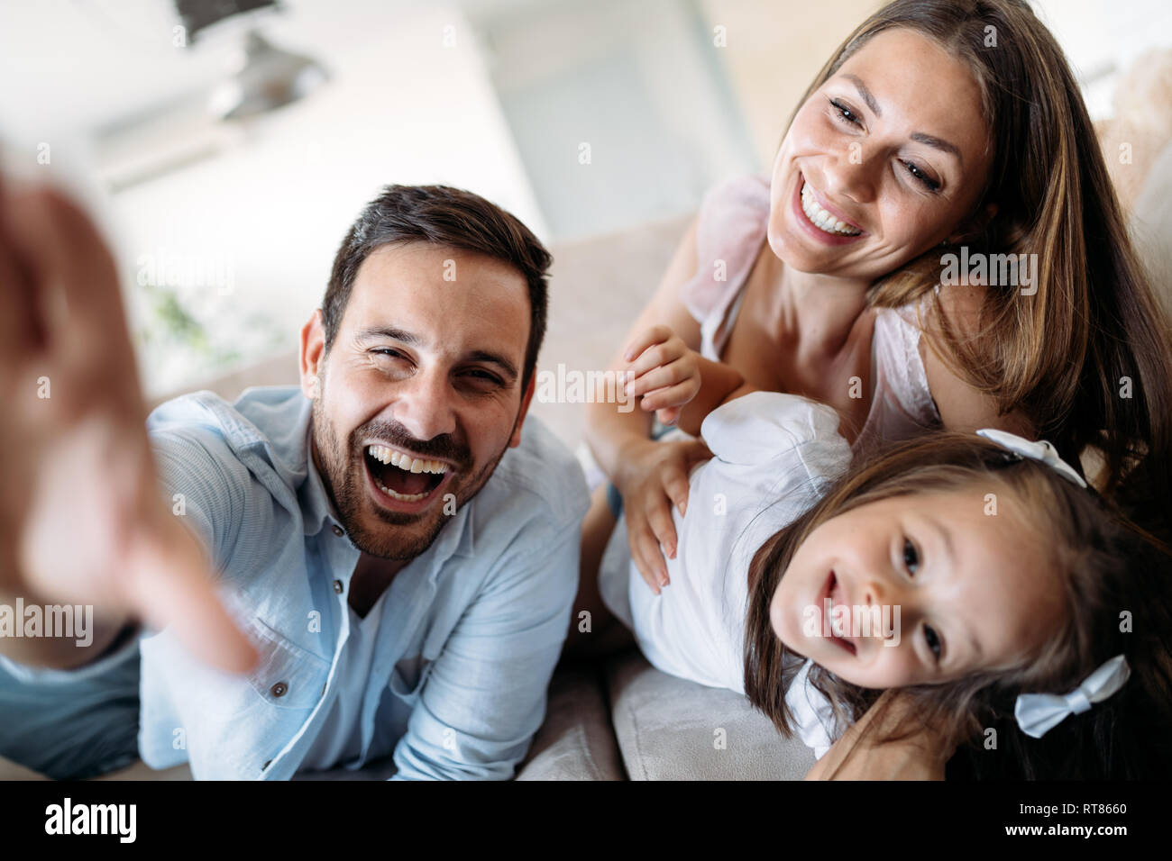 Happy family having fun time at home Stock Photo - Alamy