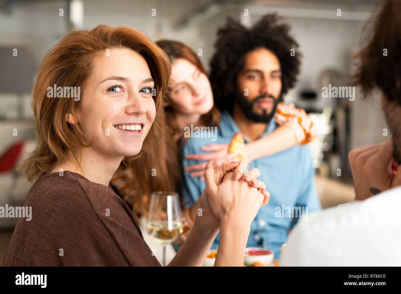 Friends having fun at a dinner party, enjoying eating together Stock ...