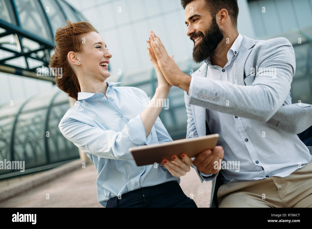 Business partners workmate couple talking in an urban city Stock Photo ...