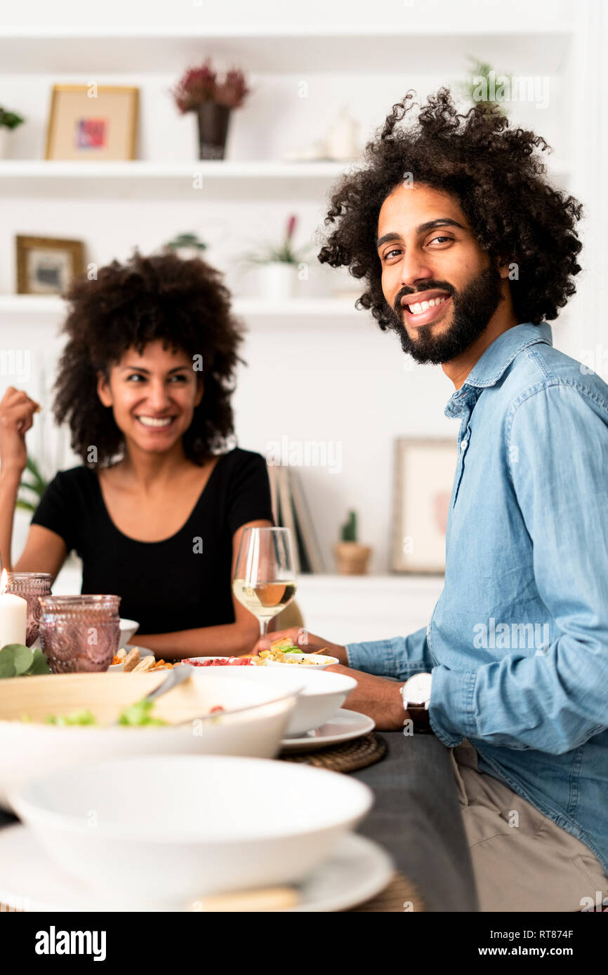 Friends having fun at a dinner party, enjoying eating together Stock ...