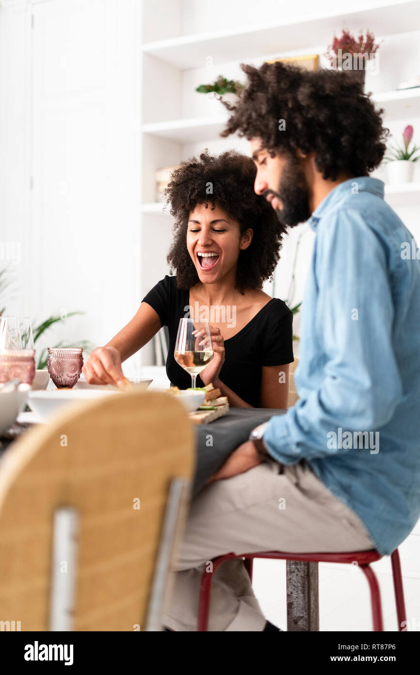 Friends having fun at a dinner party, enjoying eating together Stock ...