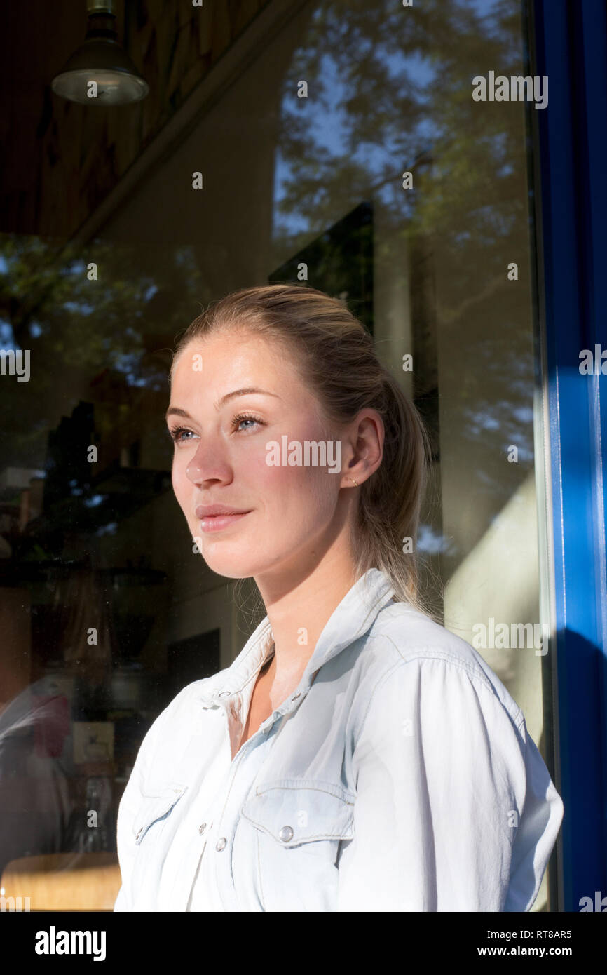 Portrait smiling woman front window looking distance hi-res stock ...