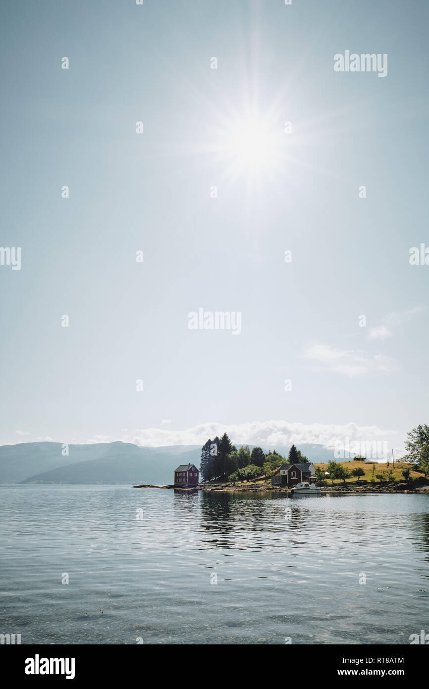 The small island of Omaholmen on a beautiful summers day in Hardangerfjord Hordaland, Norway ...